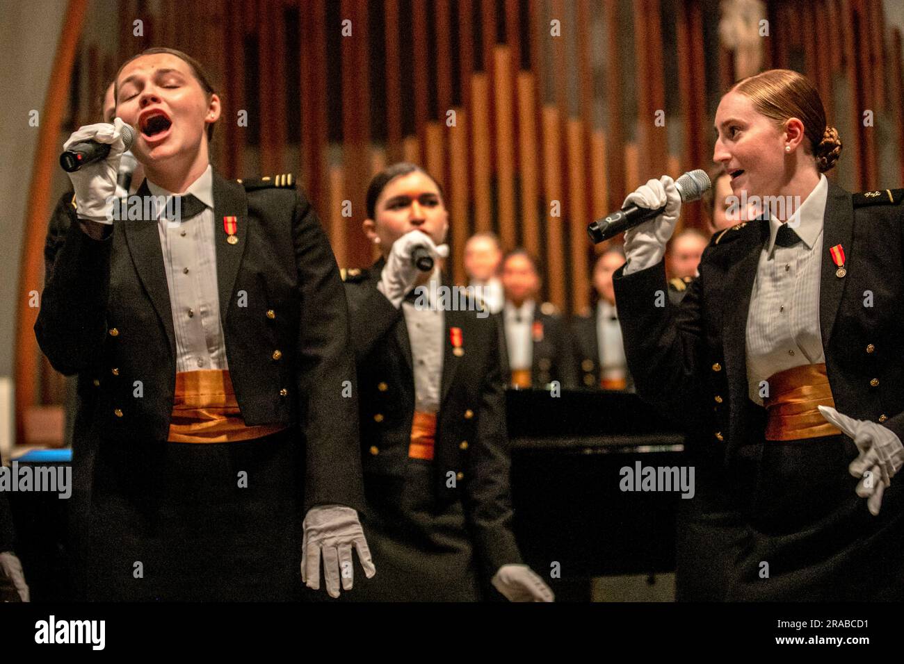 Formally dressed women members of the US Naval Academy Glee club sing ...