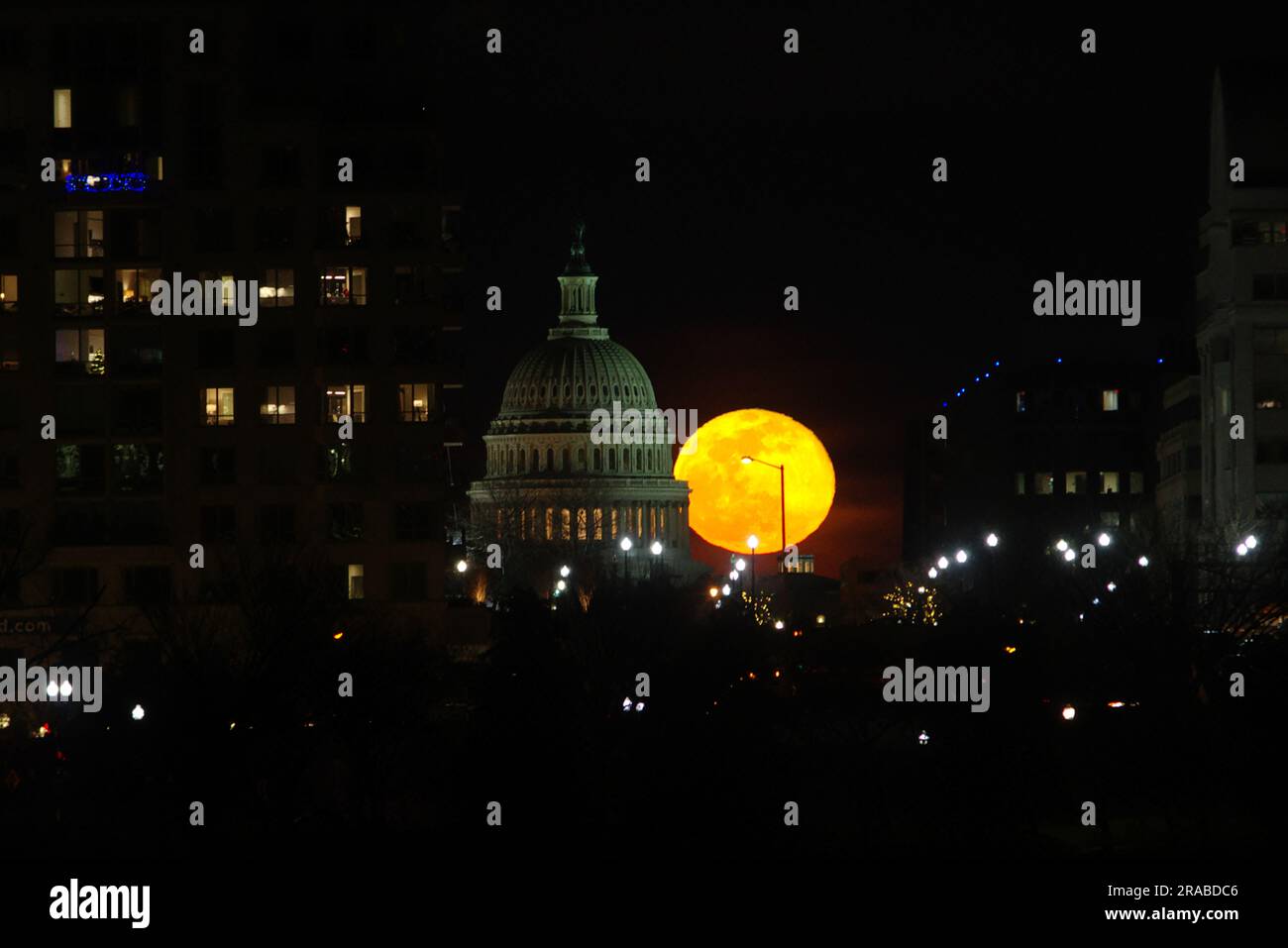 The full moon rises behind the United States Capitol dome Stock Photo ...