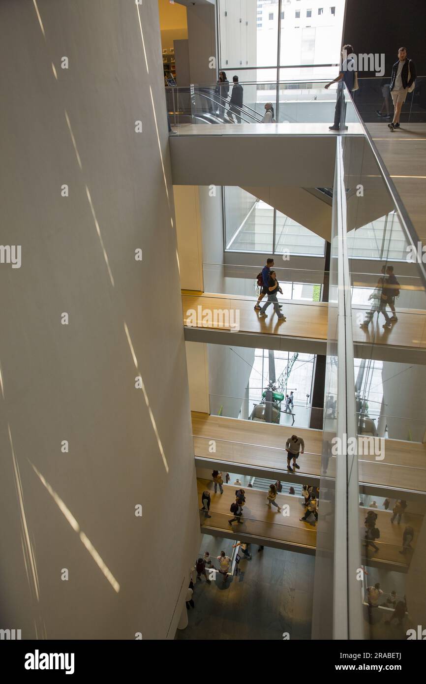 Museum goers traversing different floors in the open interior design at ...