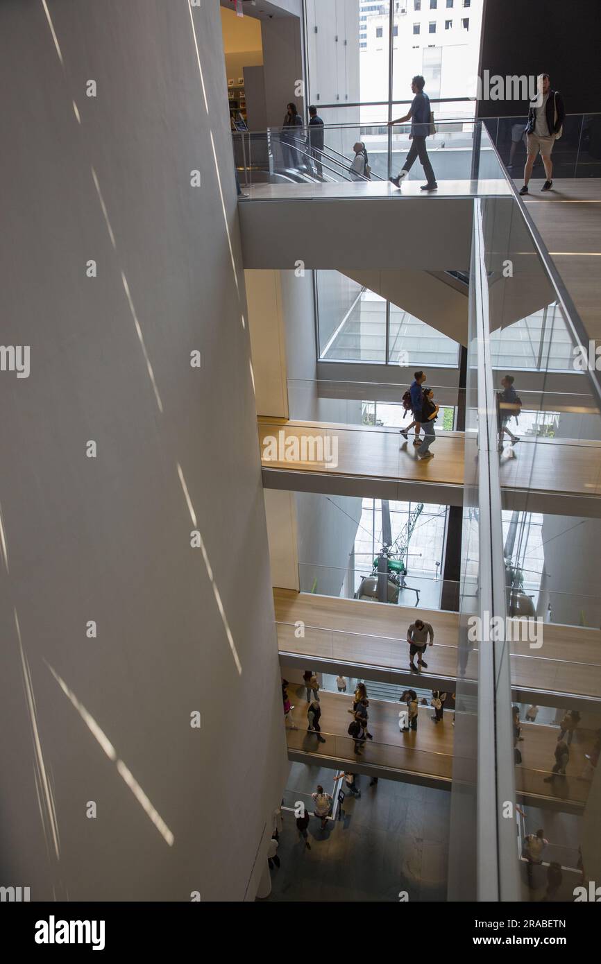 Museum goers traversing different floors in the open interior design at ...