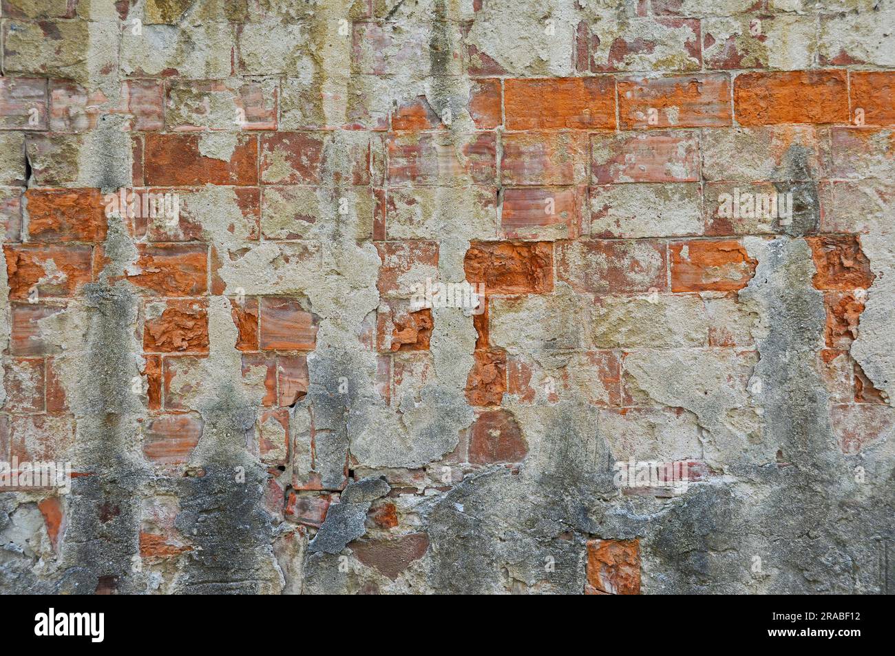 An old brick wall with cracked and chipped plaster Stock Photo - Alamy