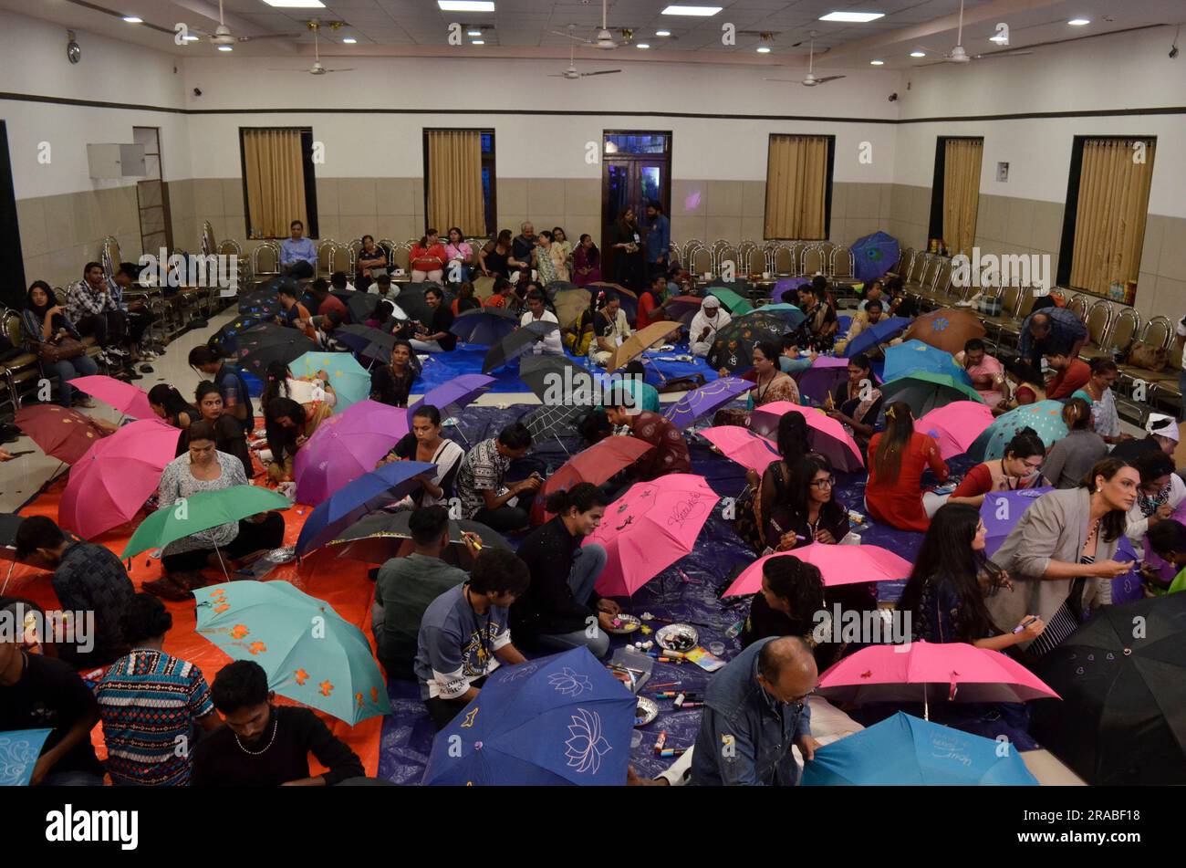 Mumbai, Maharashtra, India. 2nd July, 2023. Transgender participants paint umbrellas during an ...