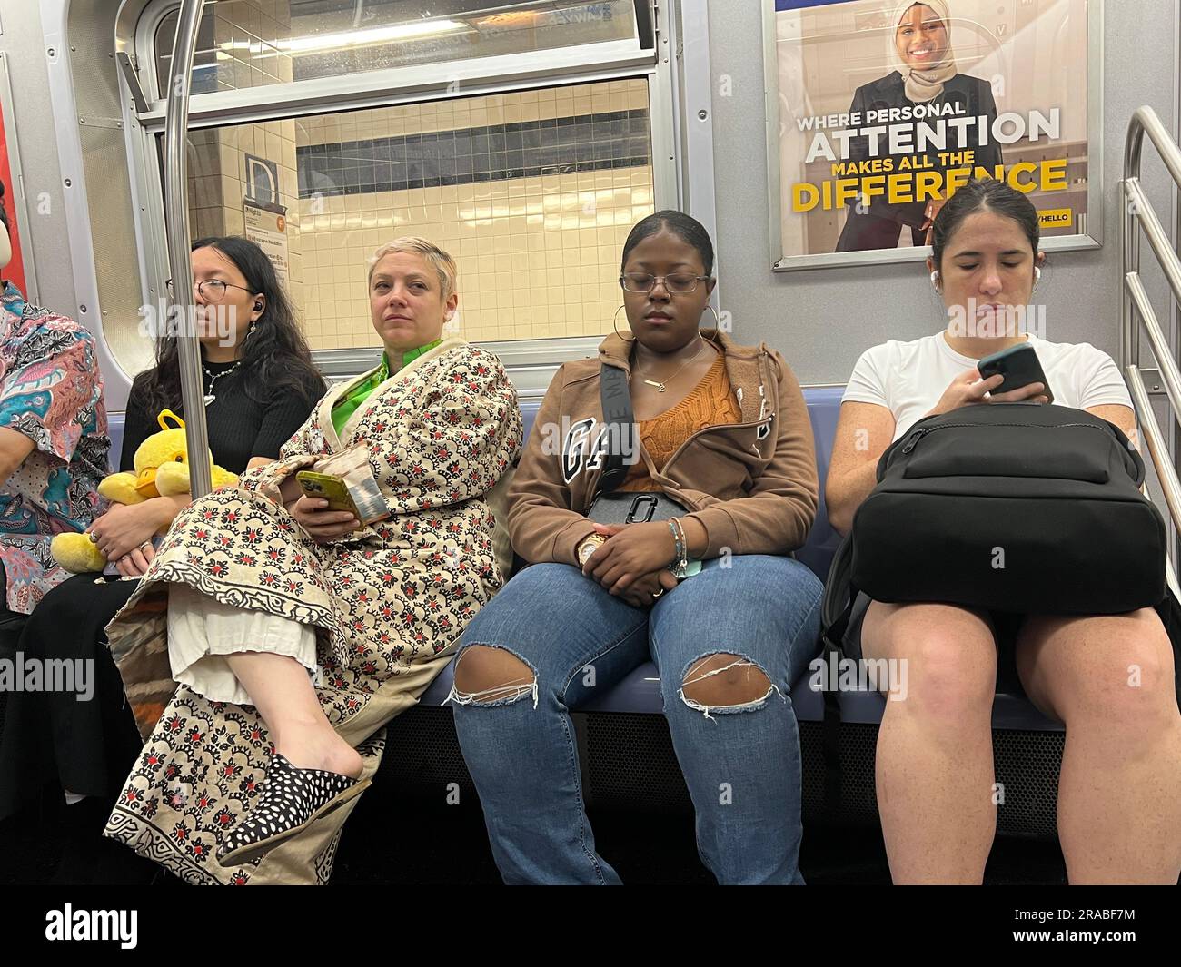 Diverse group of women riding a New York City subway train Stock Photo ...