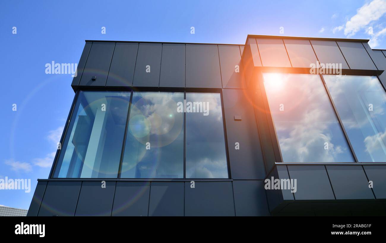 Graphite facade and large windows on a fragment of an office building ...