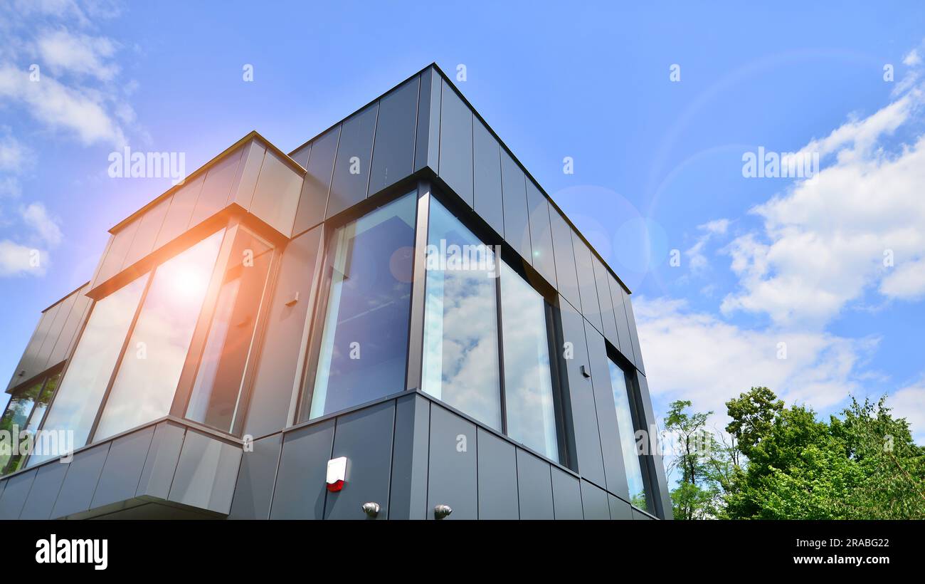 Graphite facade and large windows on a fragment of an office building ...