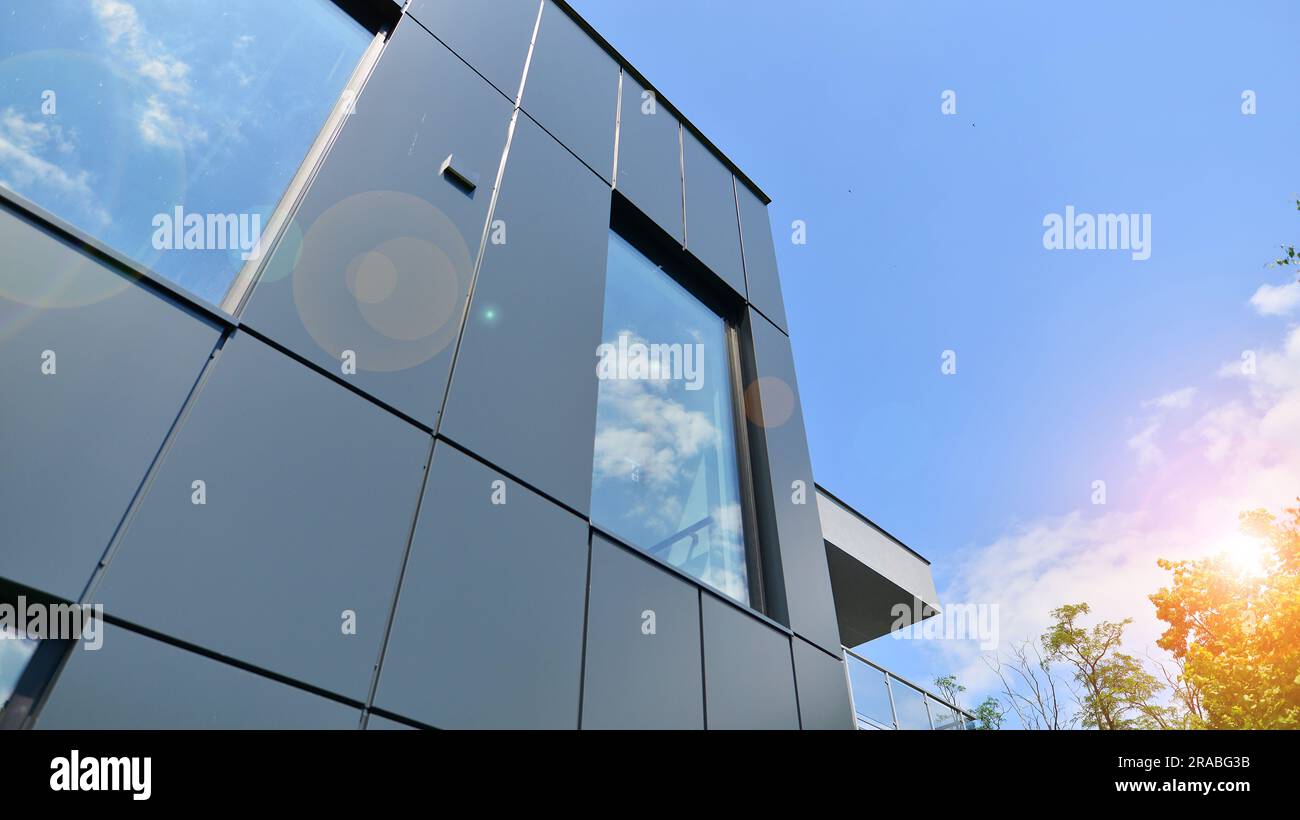 Graphite facade and large windows on a fragment of an office building ...