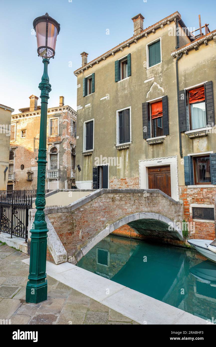 Canal with stone bridge and historic buildings in Venice, Italy, Europe ...