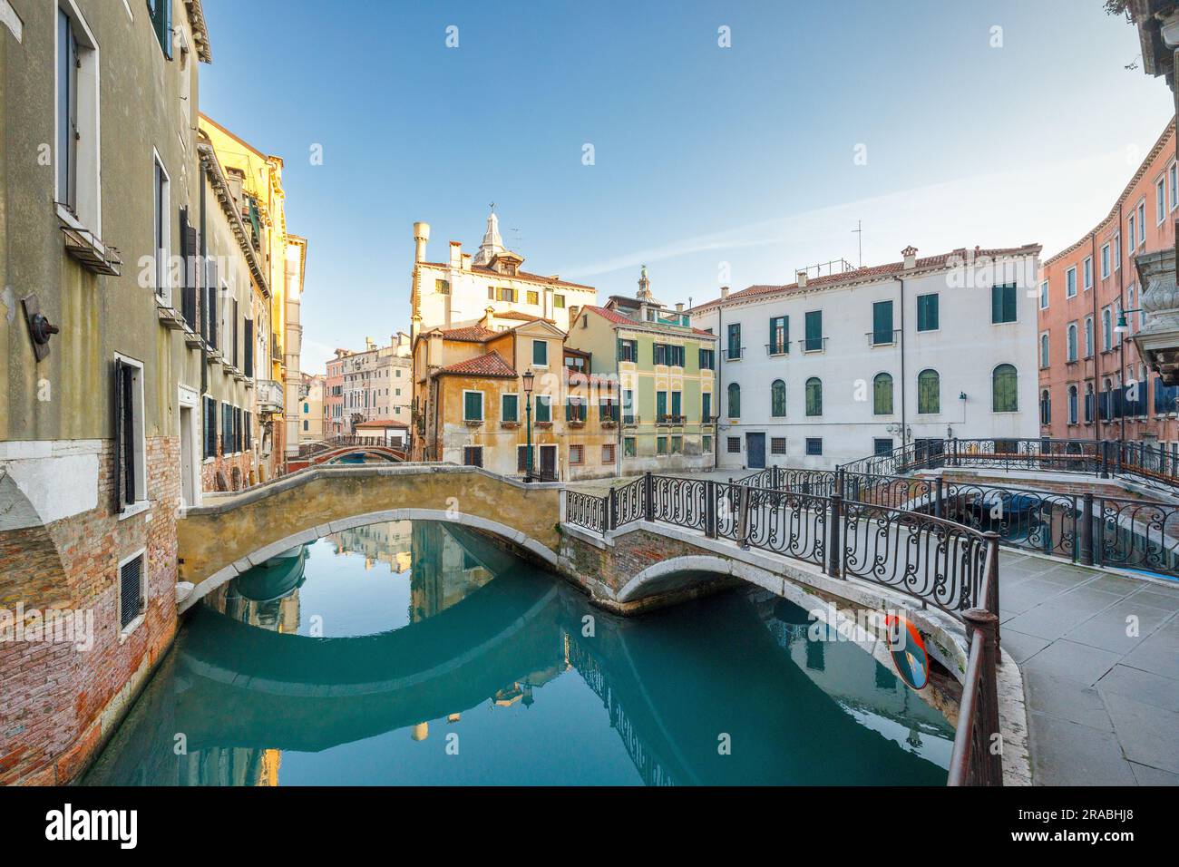 Canal with stone bridges and historic buildings in Venice, Italy ...