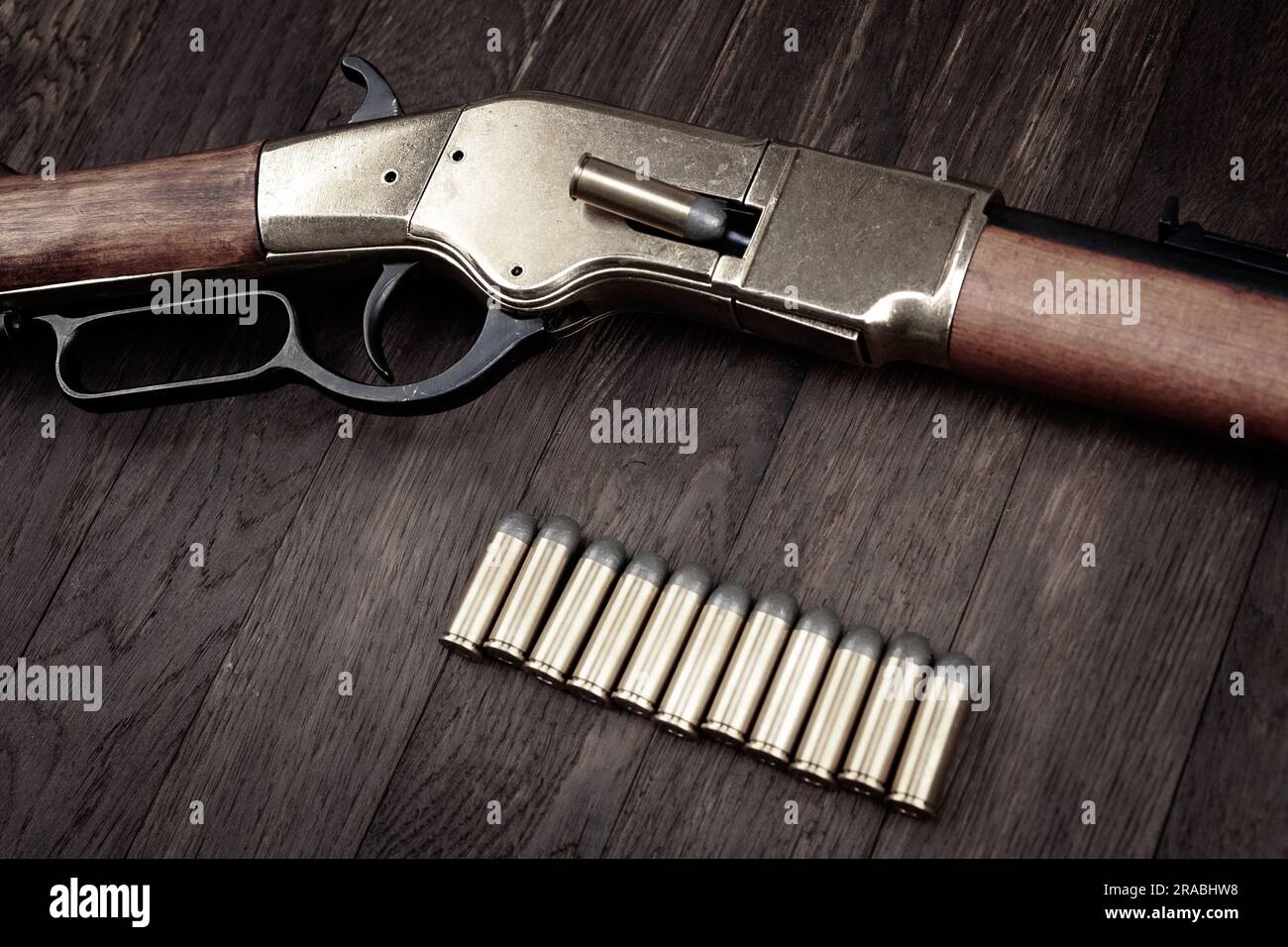 Old west guns. Lever-action repeating rifles with ammunition on wooden ...