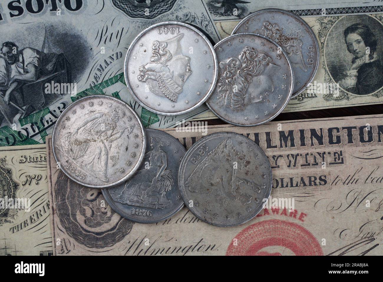 Old west US banknotes and silver certificates with silver dollar coins ...