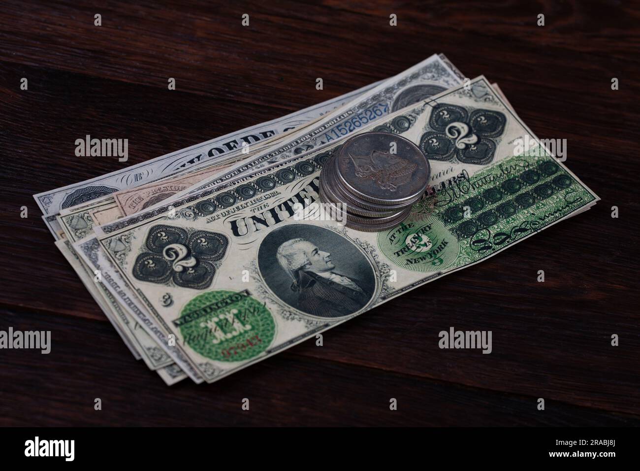 Old west US banknotes and silver certificates with silver dollar coins ...