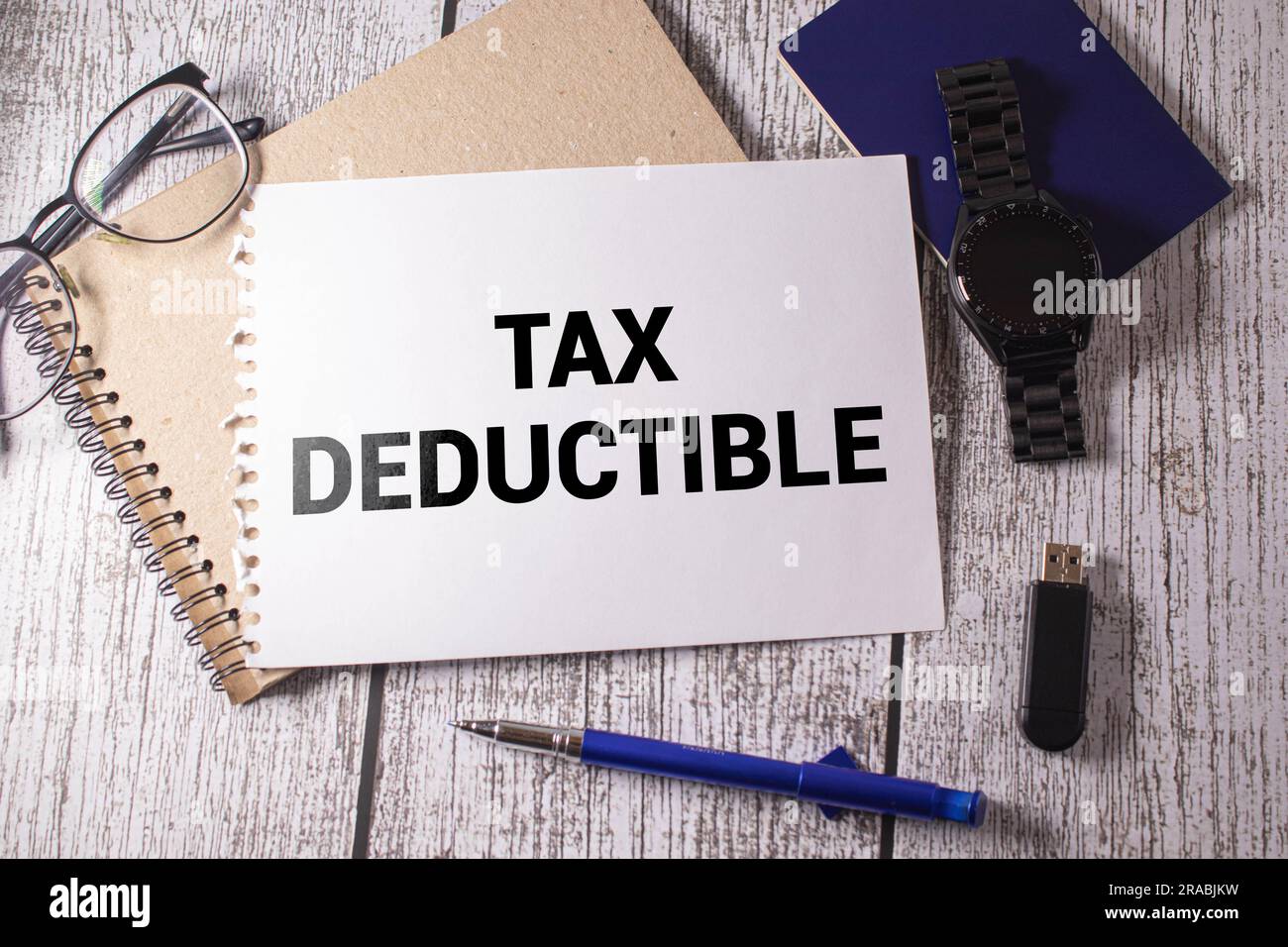 white paper with text Tax Deductions on a yellow background with ...