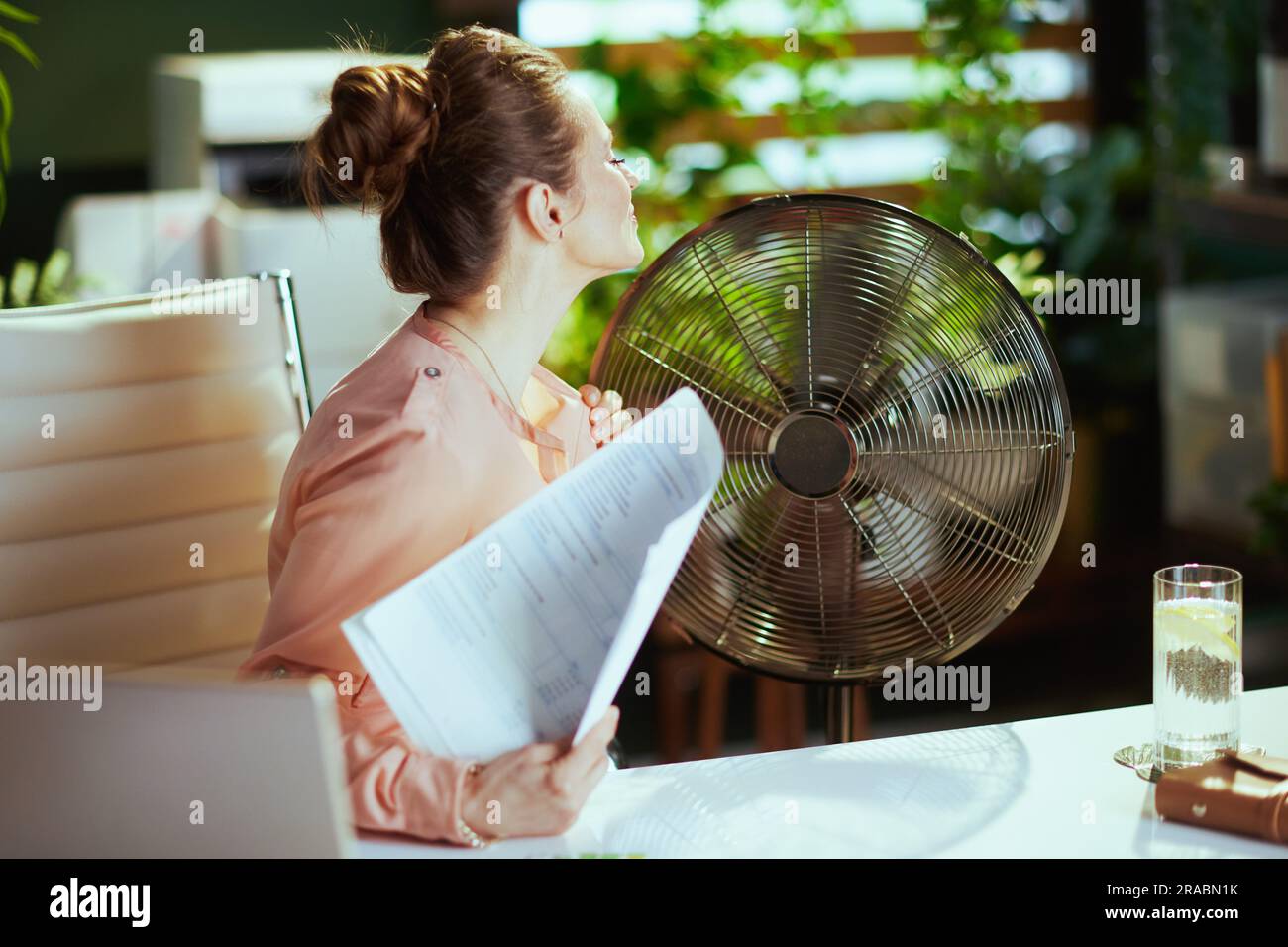 Sustainable workplace. modern woman worker at work with documents and ...