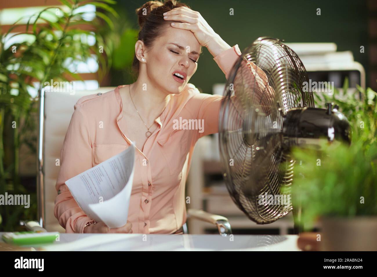 Sustainable workplace. unhappy modern small business owner woman at work with documents and ...