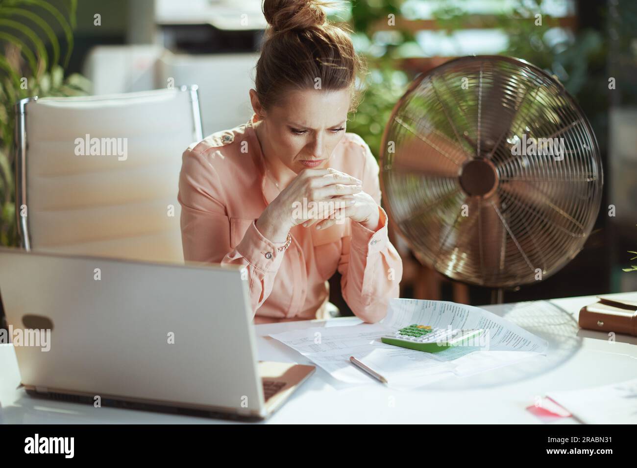Sustainable workplace. concerned modern business woman at work with ...