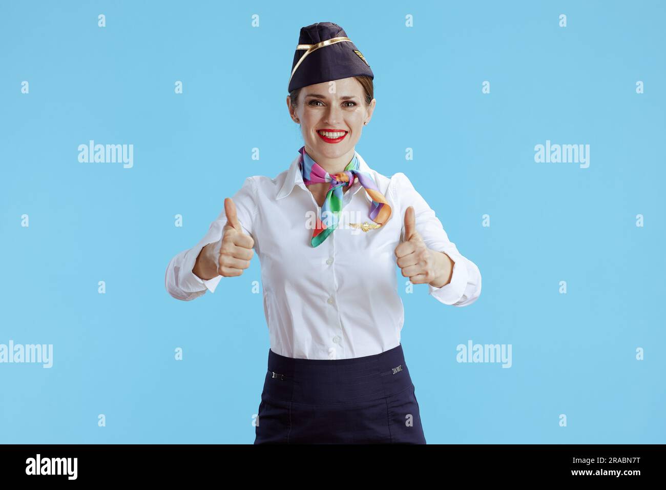 happy modern female flight attendant isolated on blue background in ...