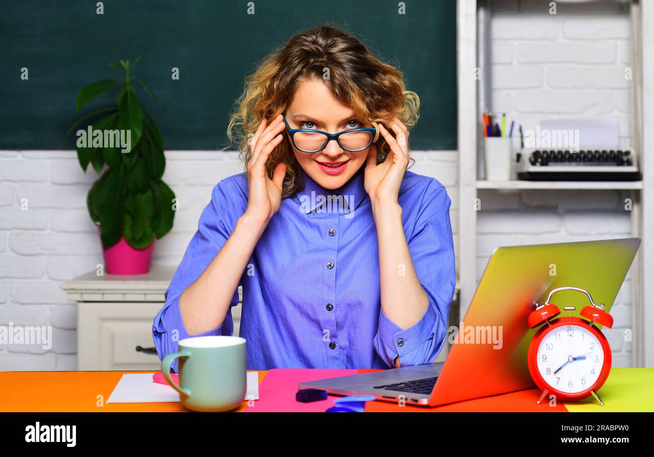 Teacher working with laptop in classroom. School job. Education and ...