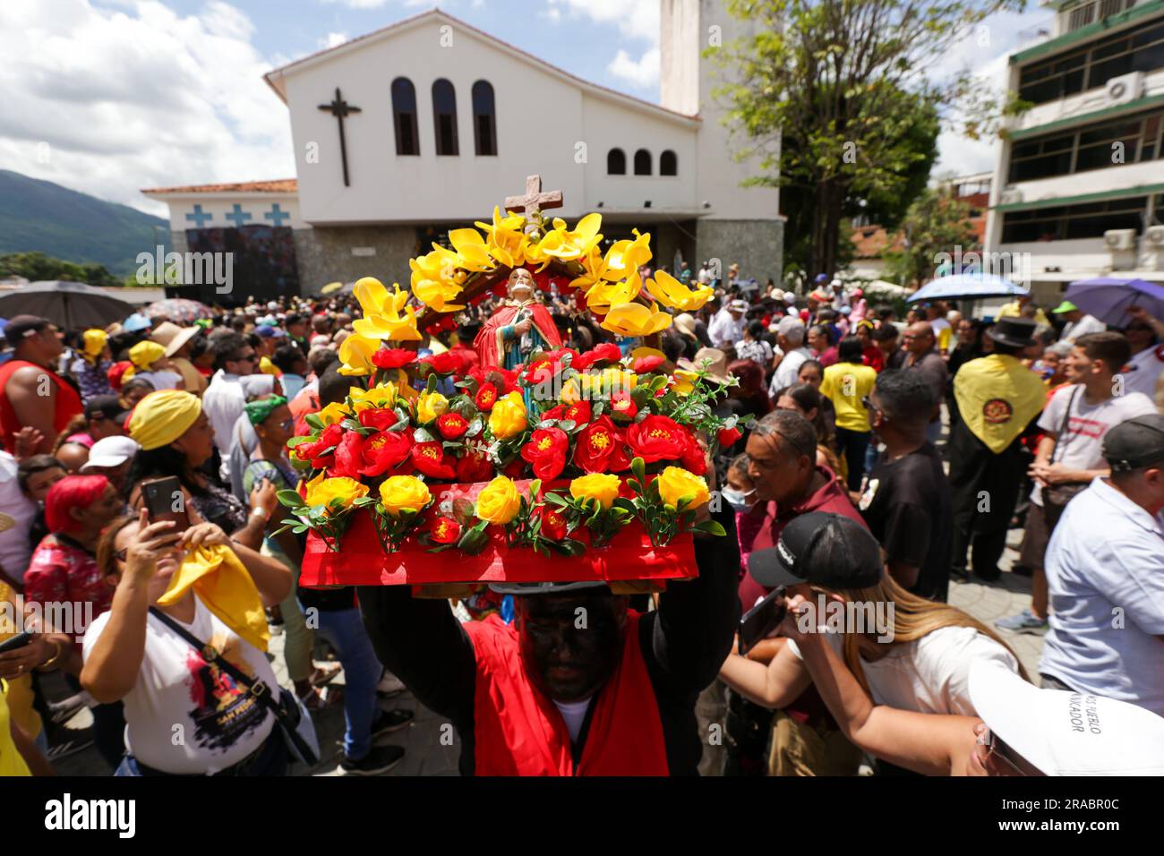 Guatire, Venezuela. 29th June, 2023. A San Pedro reveler carries the ...