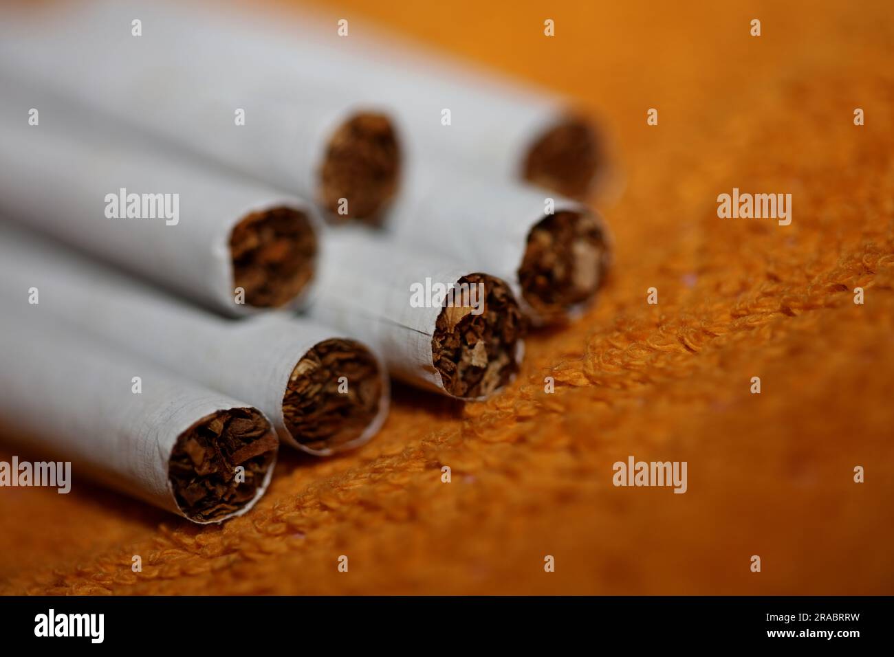 Many cigarettes in colorful background close up of a roll tobacco in ...