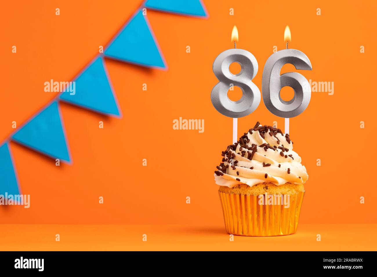 Birthday cake with candle number 86 - Orange background Stock Photo - Alamy