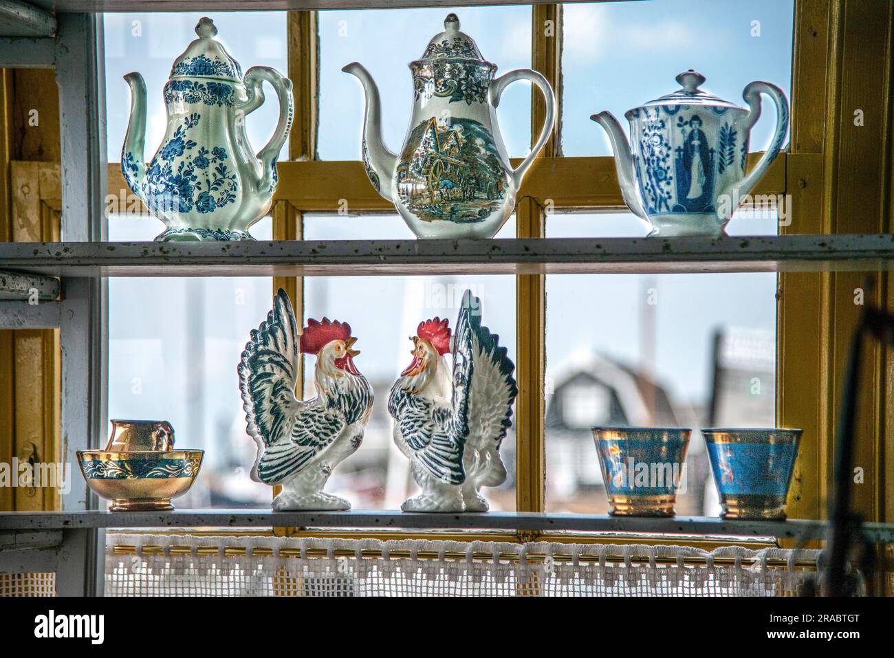 Dutch pottery ant coffee pots in a window of a Marken home Stock Photo ...
