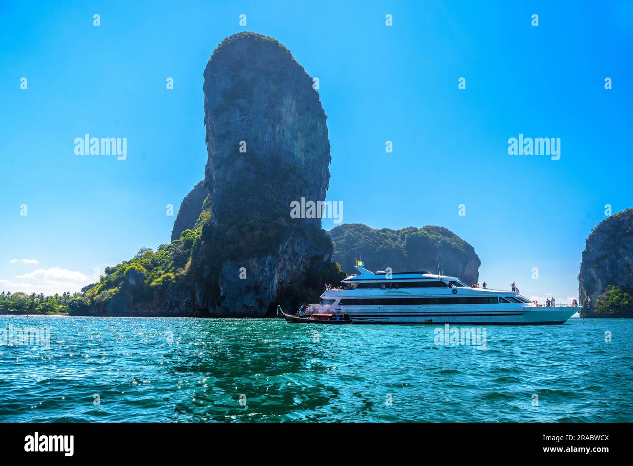 Motor ship with cliff rock in azure water, Ko Rang Nok, Ao Phra Nang ...