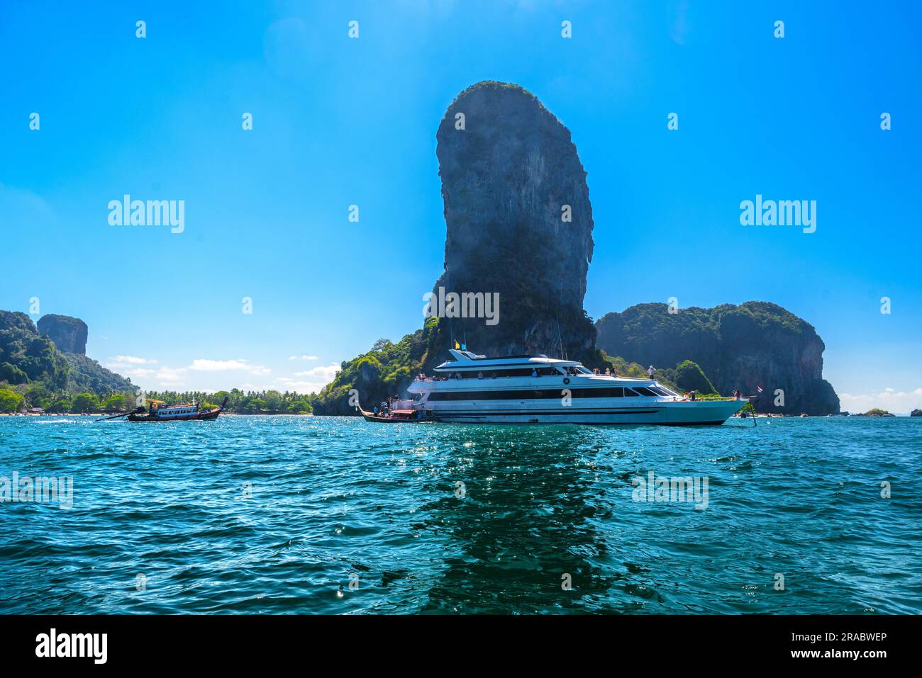 Motor ship with cliff rock in azure water, Ko Rang Nok, Ao Phra Nang ...