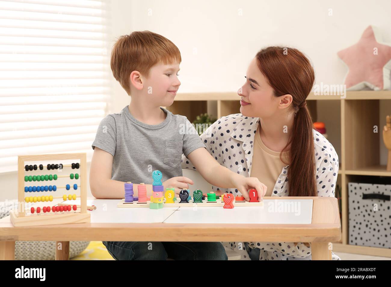 Happy mother and son playing with Educational game Fishing for Numbers ...