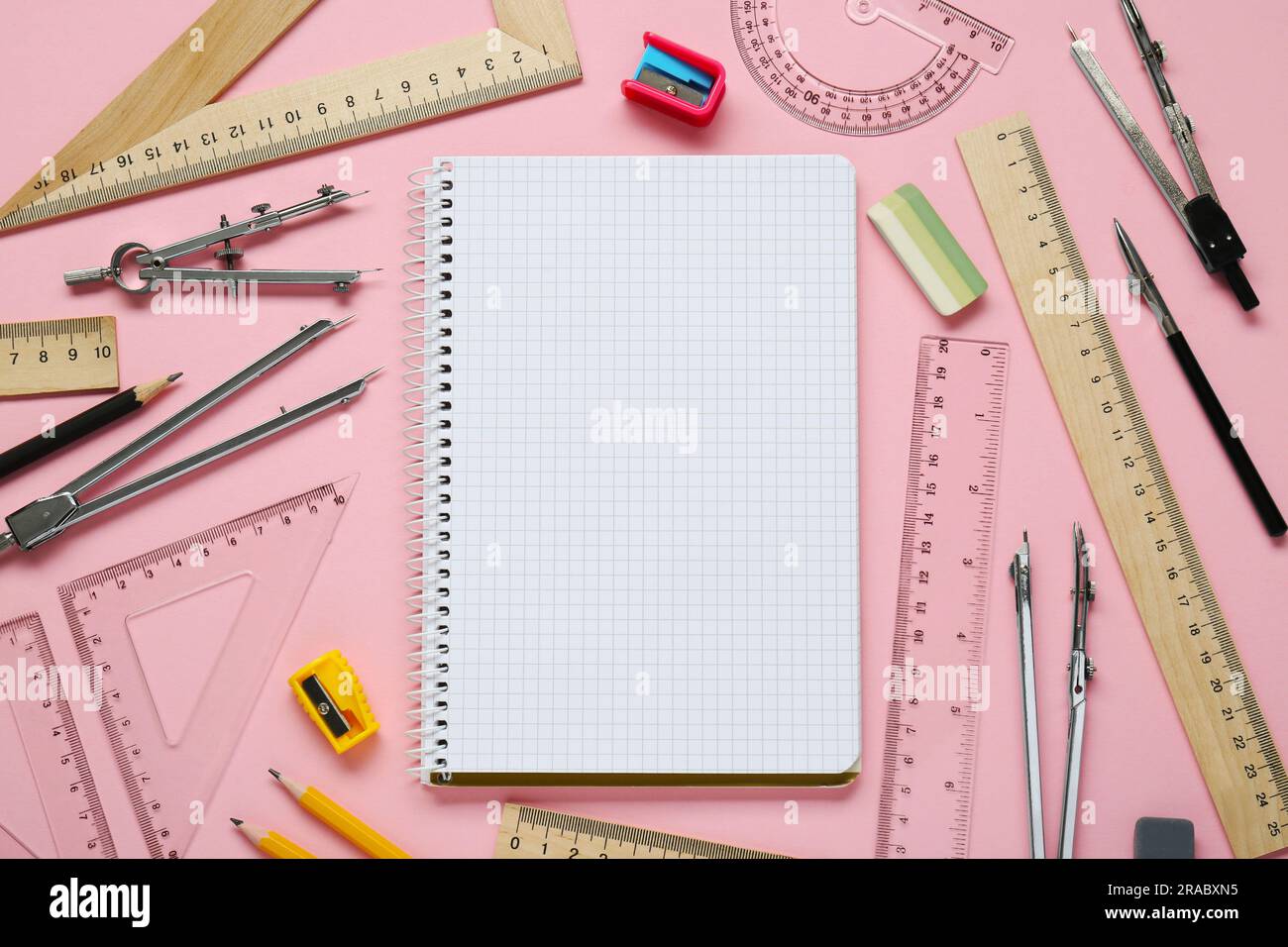 Flat lay composition with different rulers and stationery on pink ...