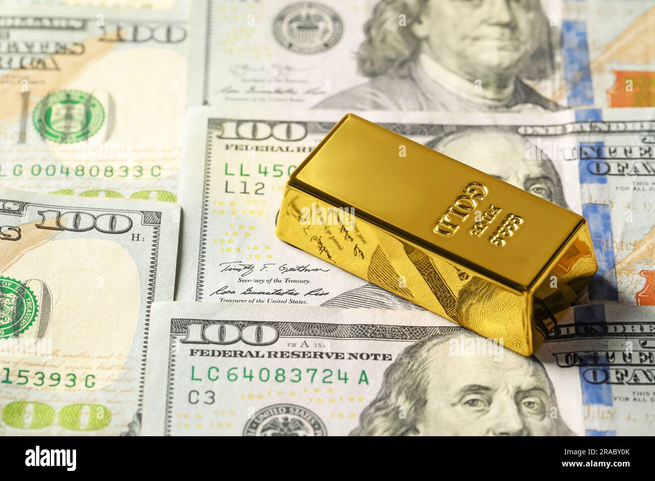 Shiny gold bar on dollar banknotes, closeup. Space for text Stock Photo ...