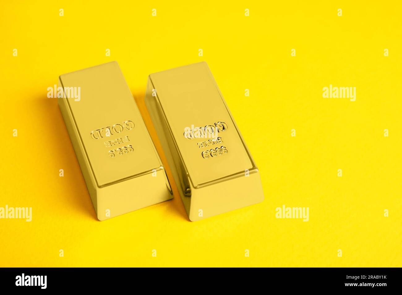 Shiny gold bars on yellow background, space for text Stock Photo - Alamy