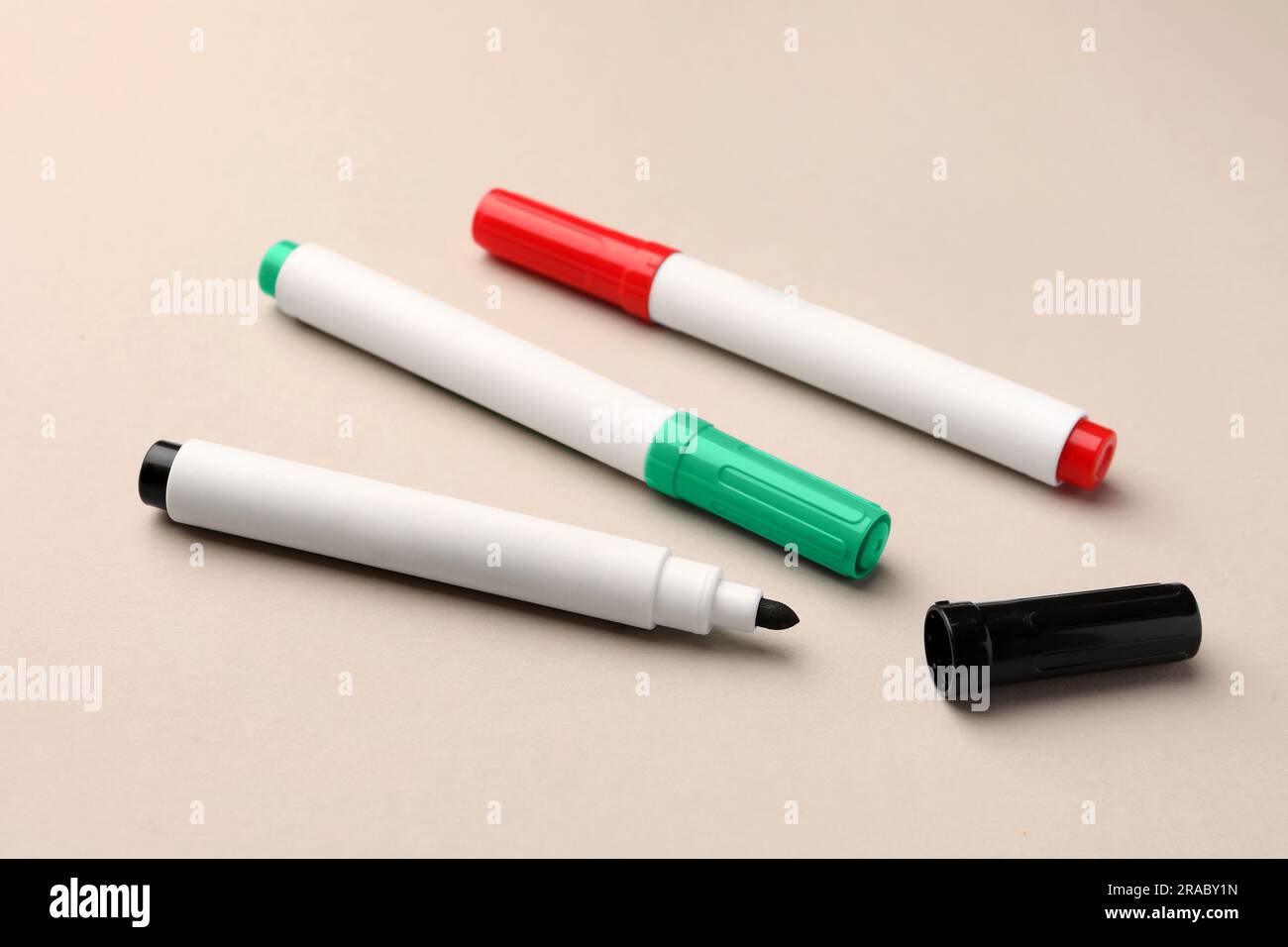 Bright color markers on beige background. Office stationery Stock Photo ...