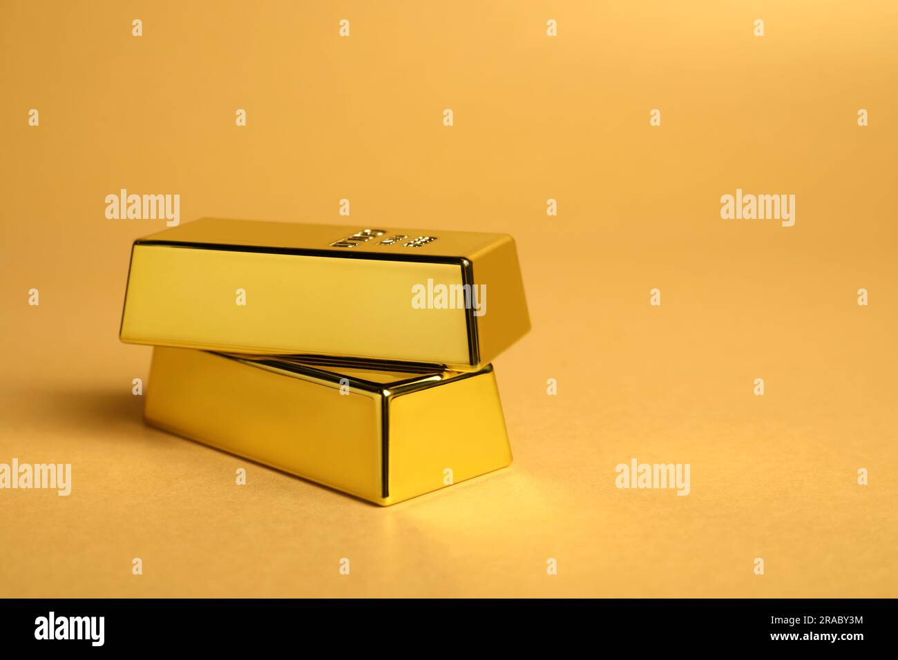 Shiny gold bars on pale orange background, closeup. Space for text Stock Photo - Alamy