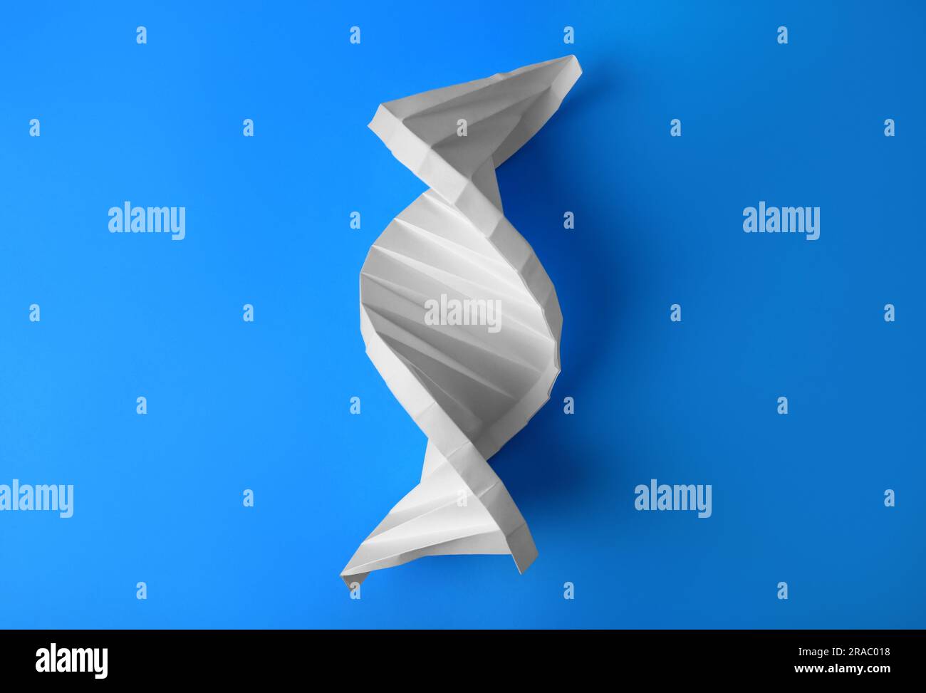 Paper model of DNA molecular chain on light blue background, top view ...