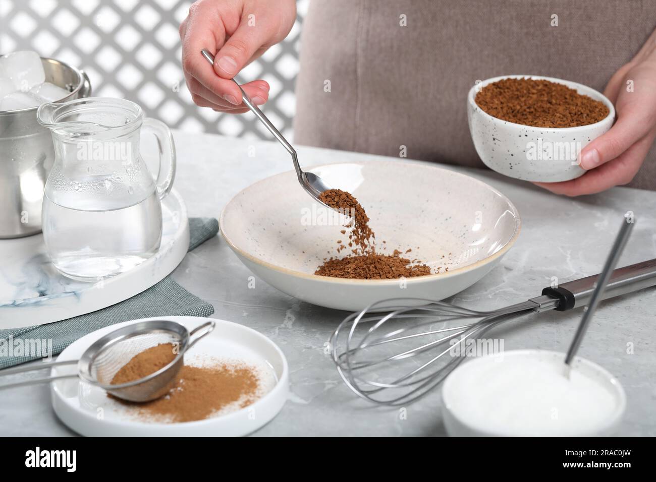 Making dalgona coffee. Woman pouring instant granules into bowl at ...