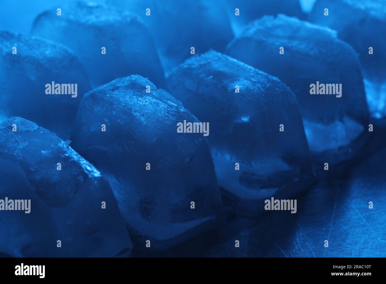 Crystal clear ice cubes on light blue background, closeup. Color tone effect Stock Photo - Alamy