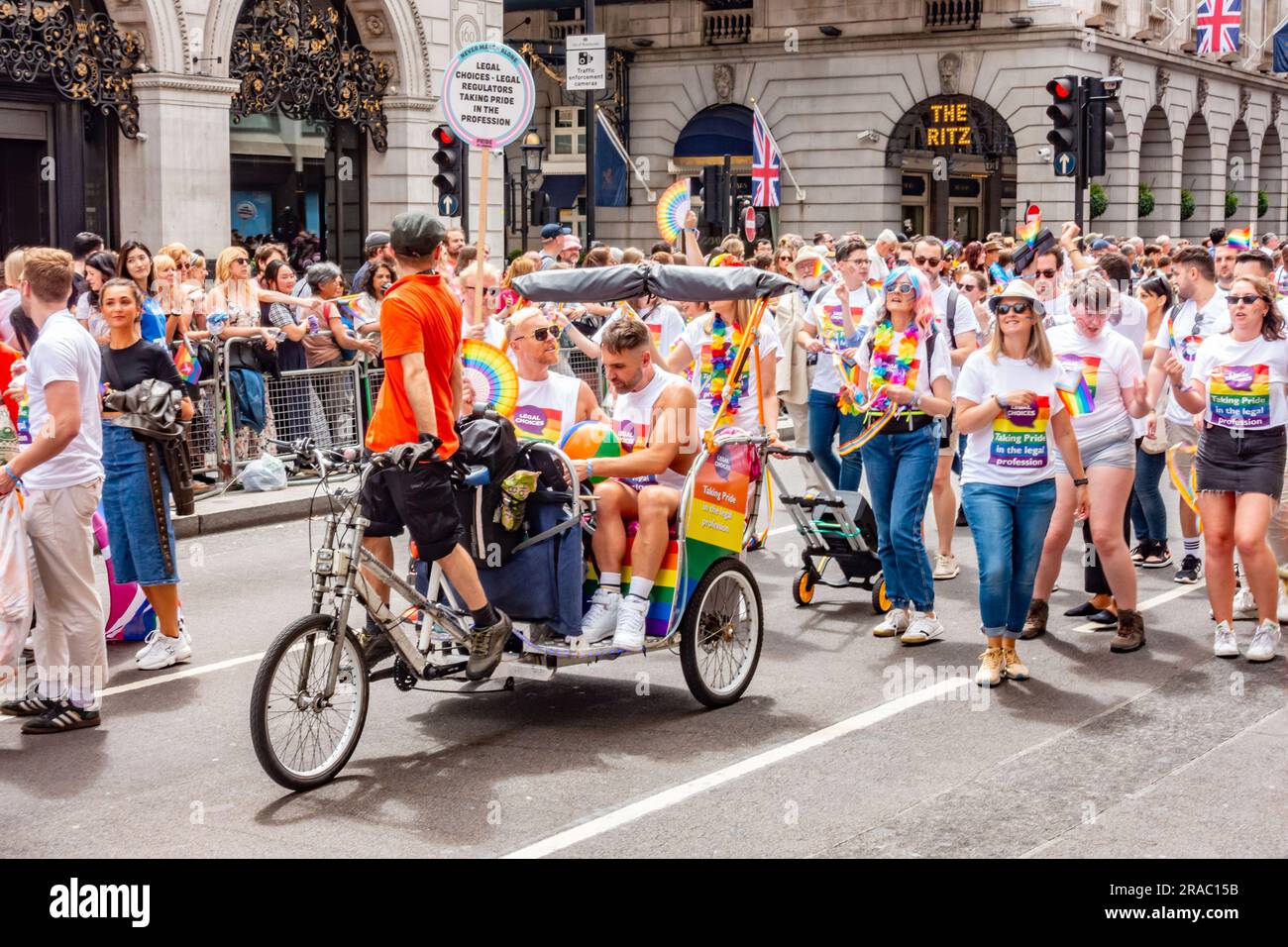 People riding in a tricycle as part of the London Pride 2023 parade ...