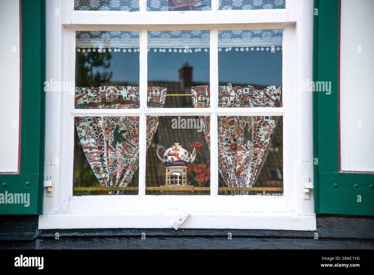pretty Dutch window with curtain and a teapot Stock Photo - Alamy