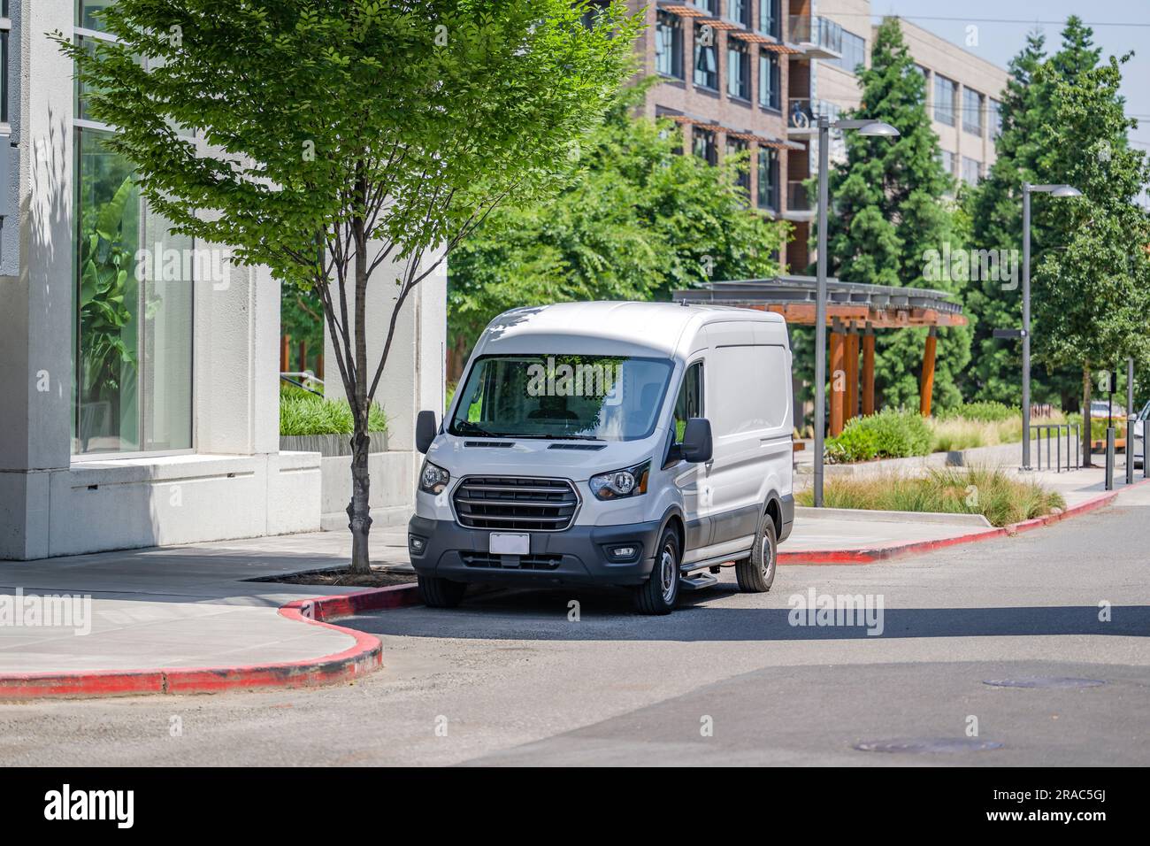 White compact light duty maneuverable economical cargo mini van making ...