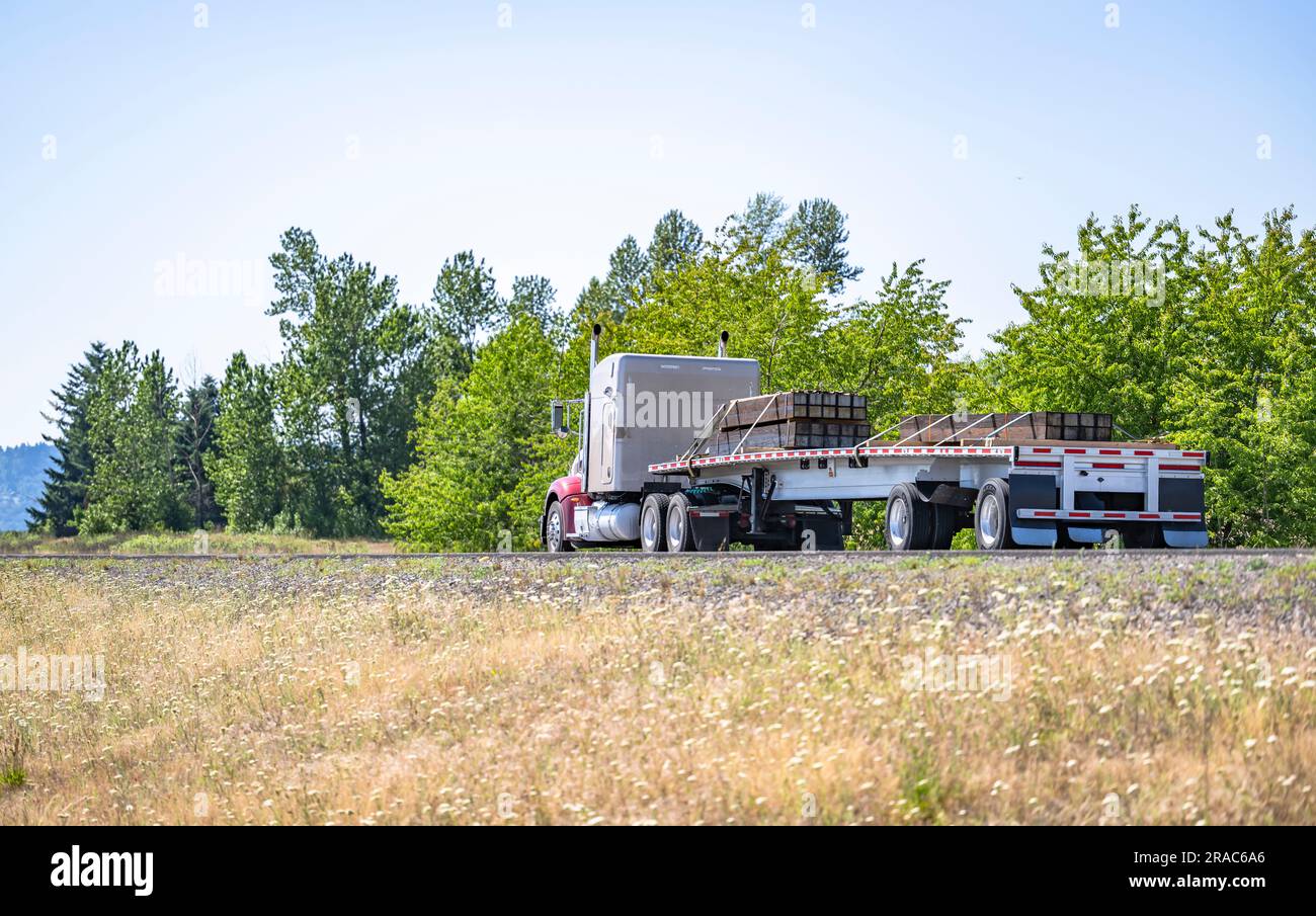 Industrial beige big rig semi truck with extended cab transporting ...