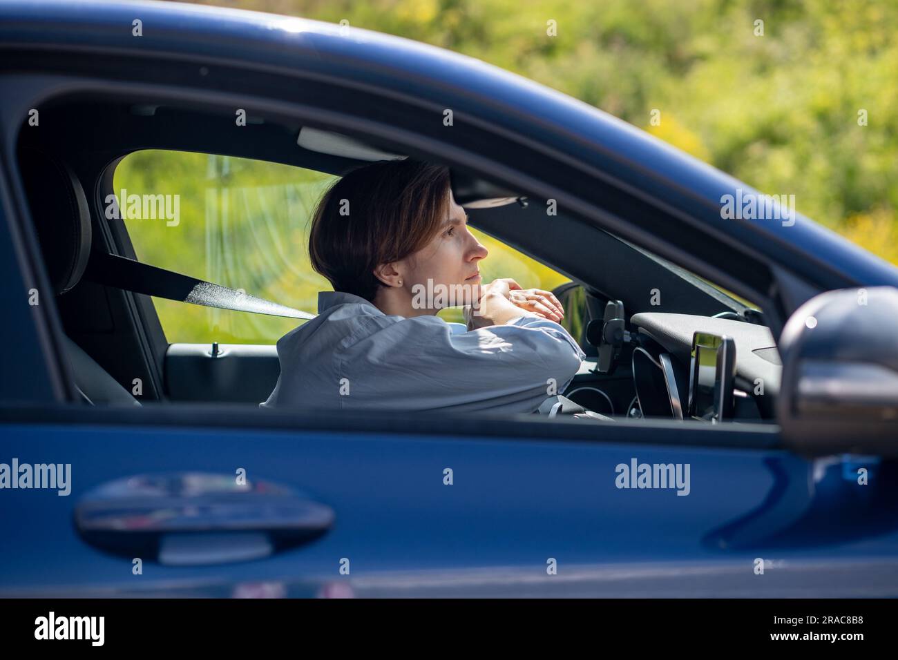 Pensive serious woman standing in traffic jam waiting driving car ...