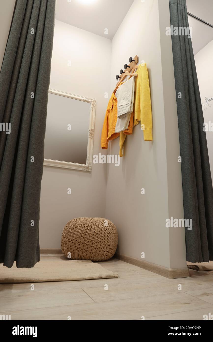 Dressing room with mirror in fashion store, low angle view. Stylish ...