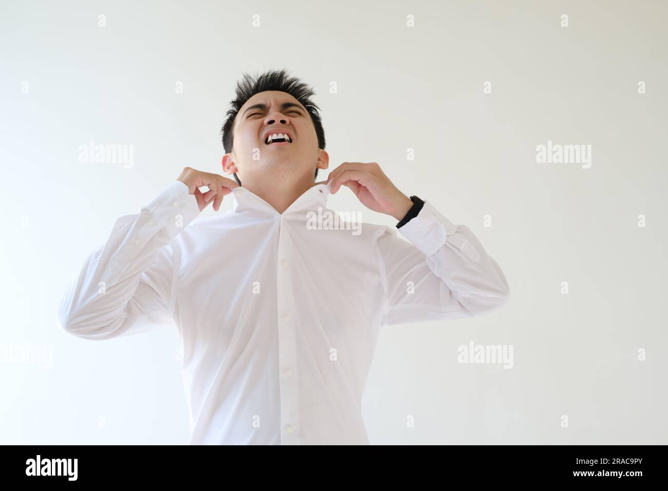 Young Asian man wearing a white shirt and a black watch flicked the ...