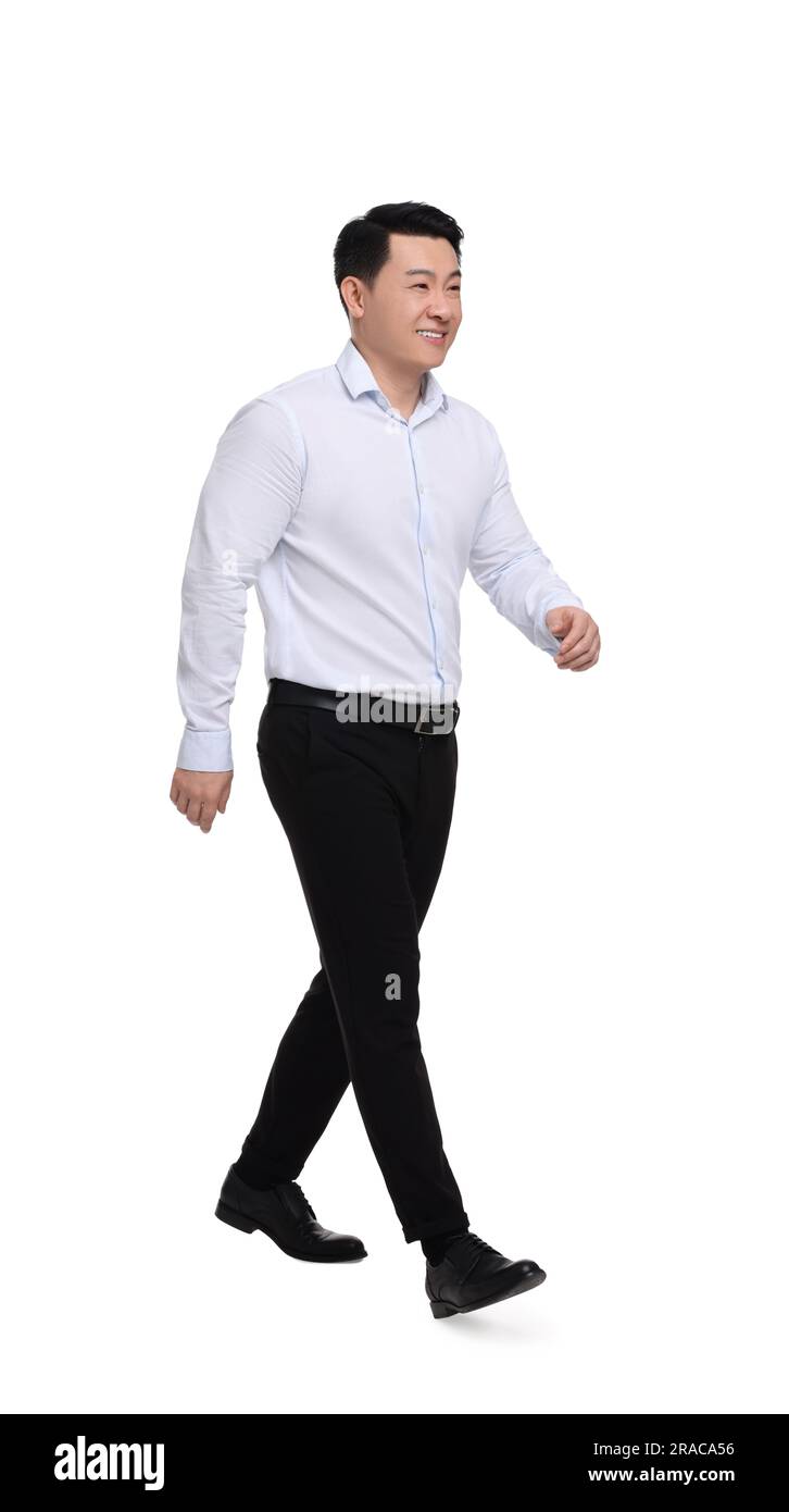 Businessman in formal clothes walking on white background Stock Photo ...