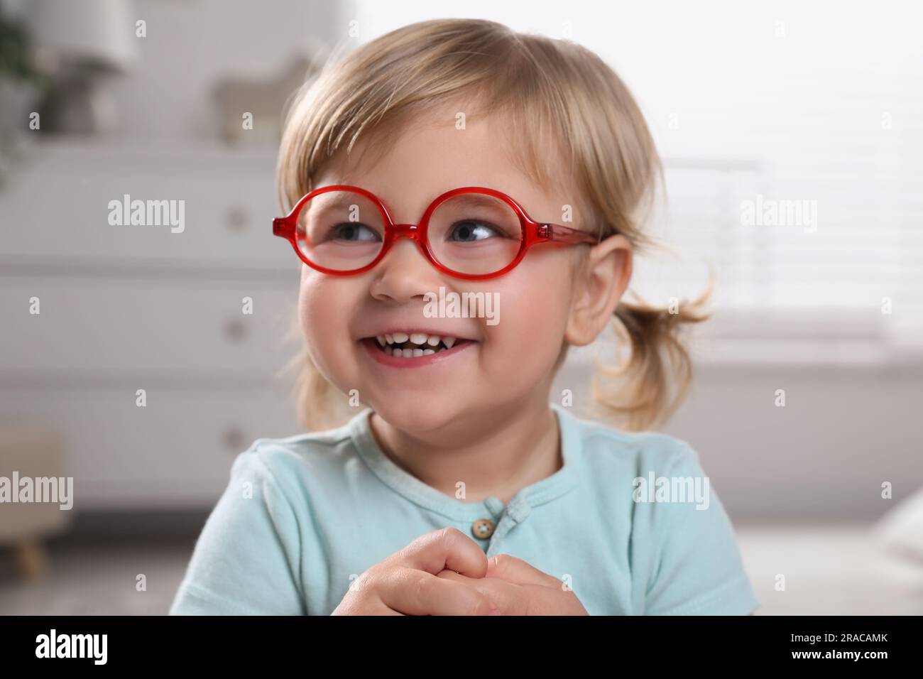 Cute little girl in glasses at home Stock Photo - Alamy