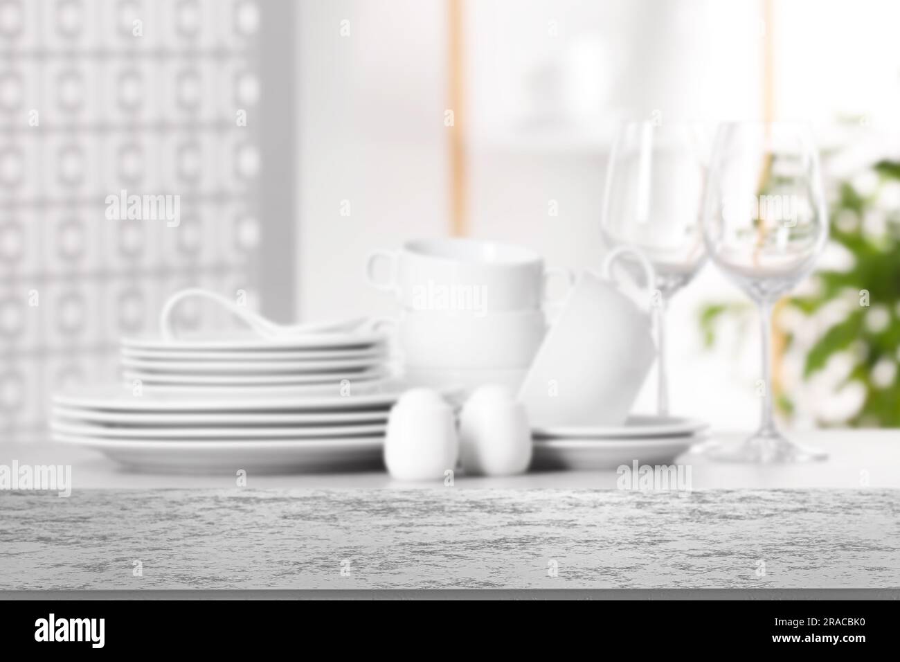 Set of clean dishware, focus on empty stone table Stock Photo - Alamy