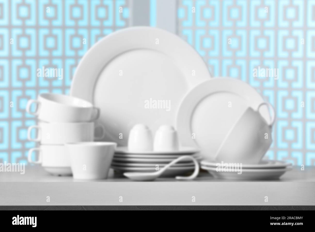 Set of clean dishware, focus on empty stone table Stock Photo - Alamy