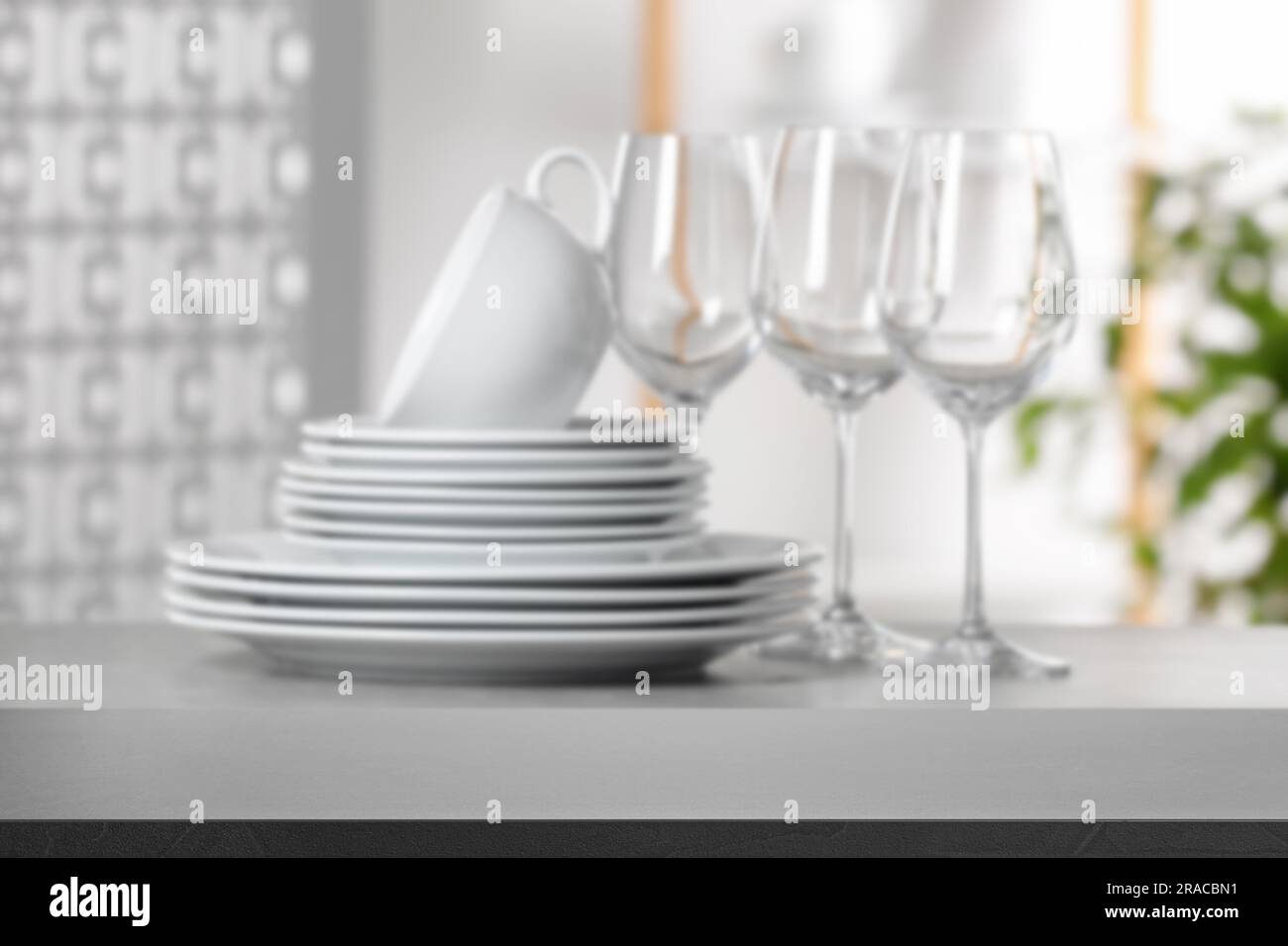 Set of clean dishware, focus on empty stone table Stock Photo - Alamy