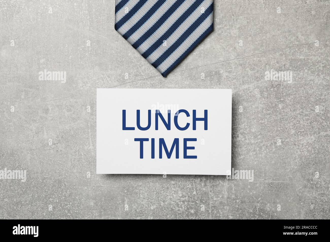Business lunch. Card with phrase Lunch Time and striped tie on light ...