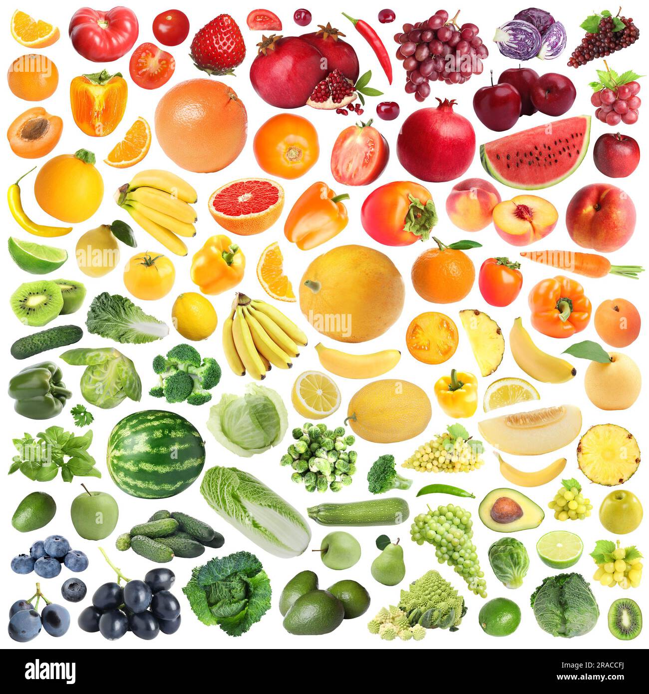 Many fresh fruits and vegetables arranged in rainbow colors on white ...